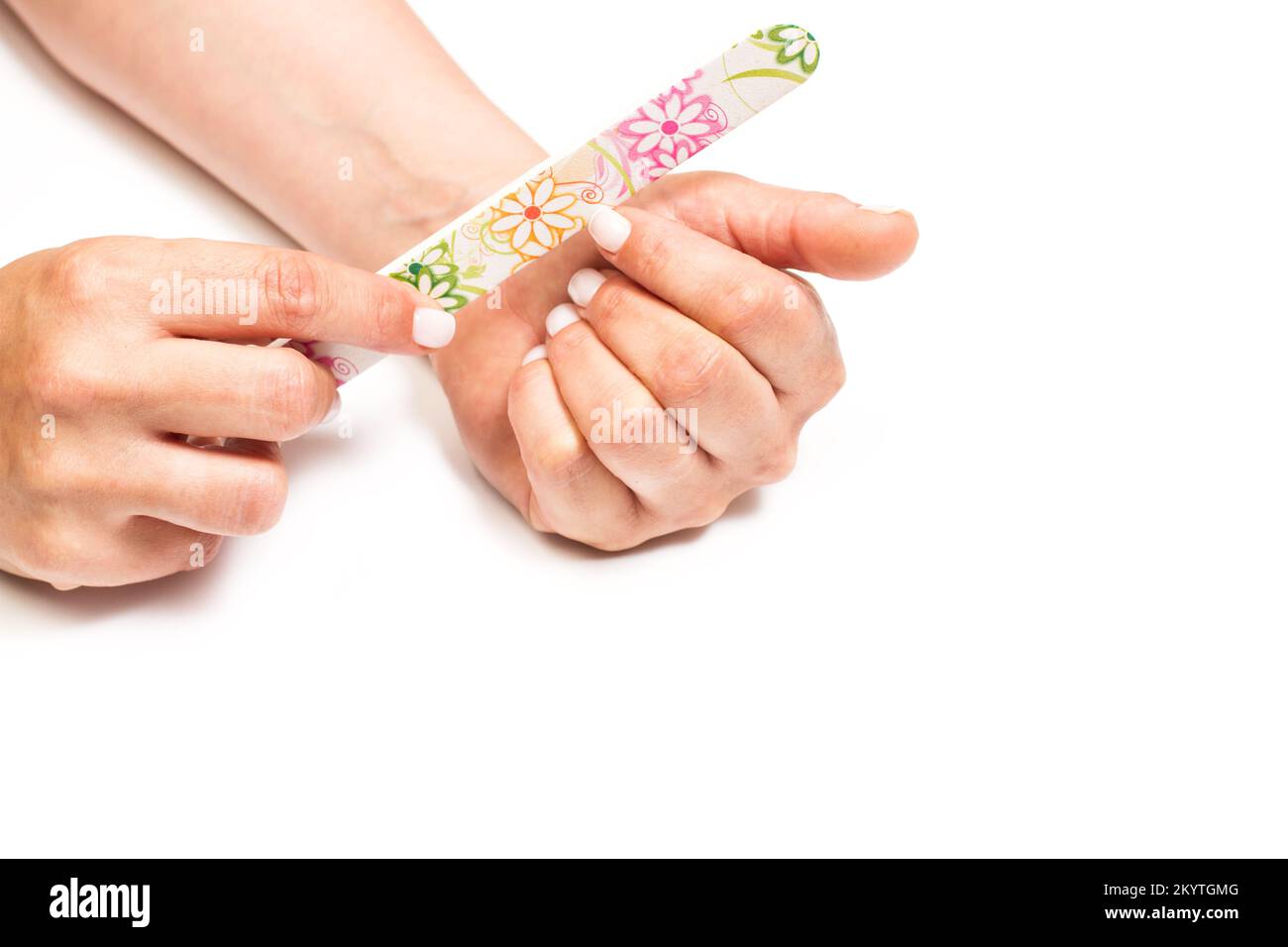 Woman filing her nails with a colored file on a white background with ...