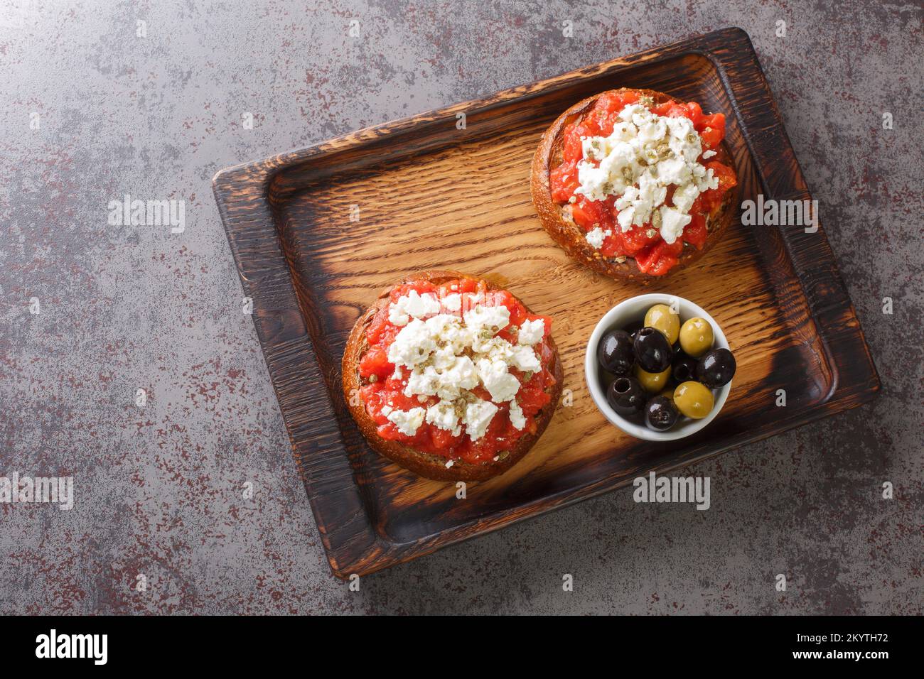 Greek dakos appetizer with barley rusk, tomatoes, feta cheese, oregano ...