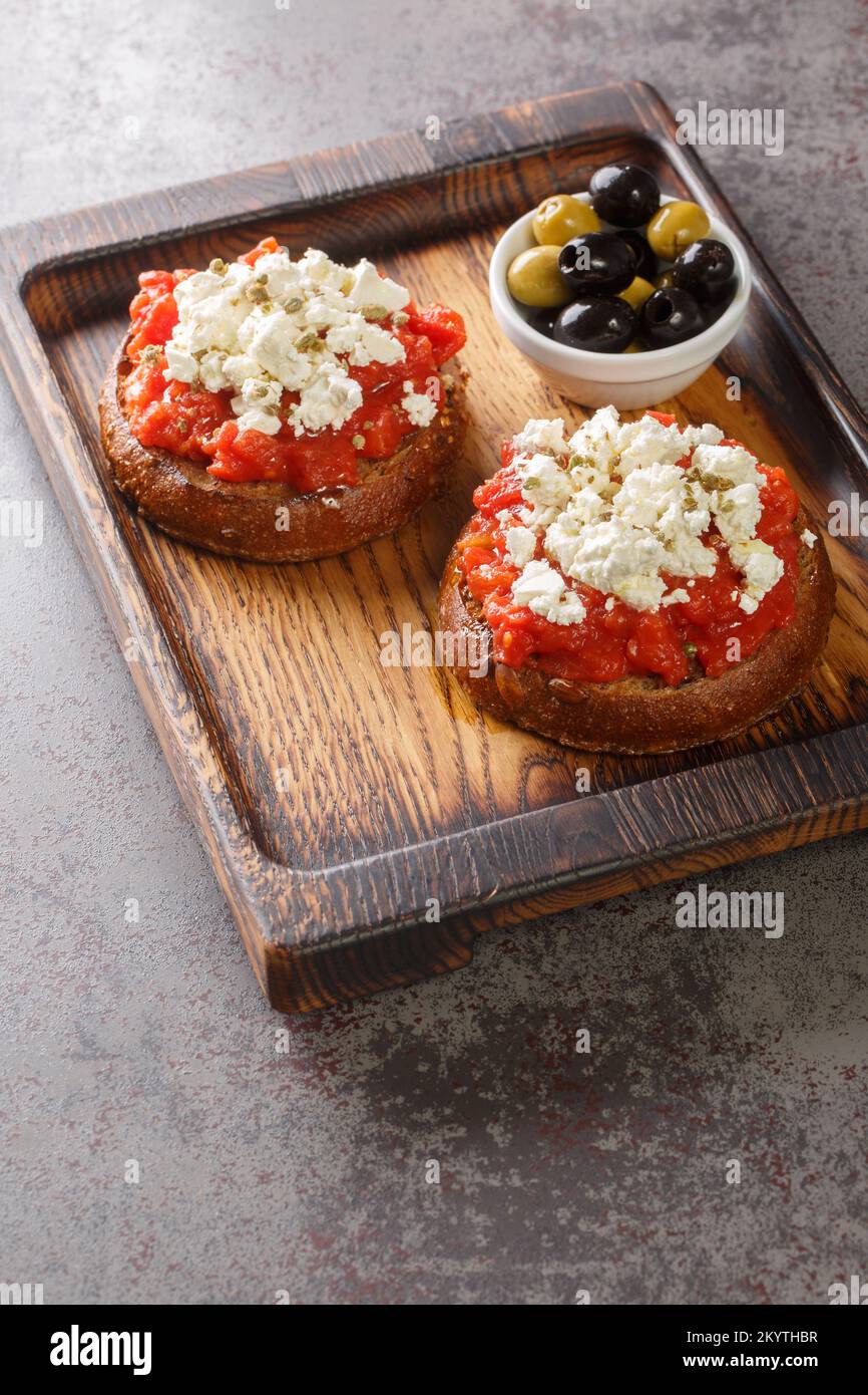 Dakos Cretan Meze appetizer with barley rusk, tomatoes, feta cheese ...