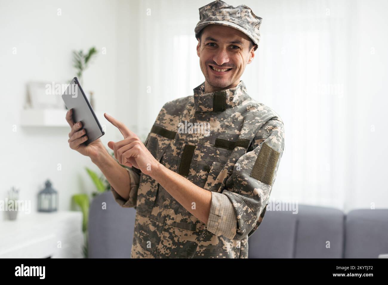 Male soldier using tablet computer on white background. Military ...