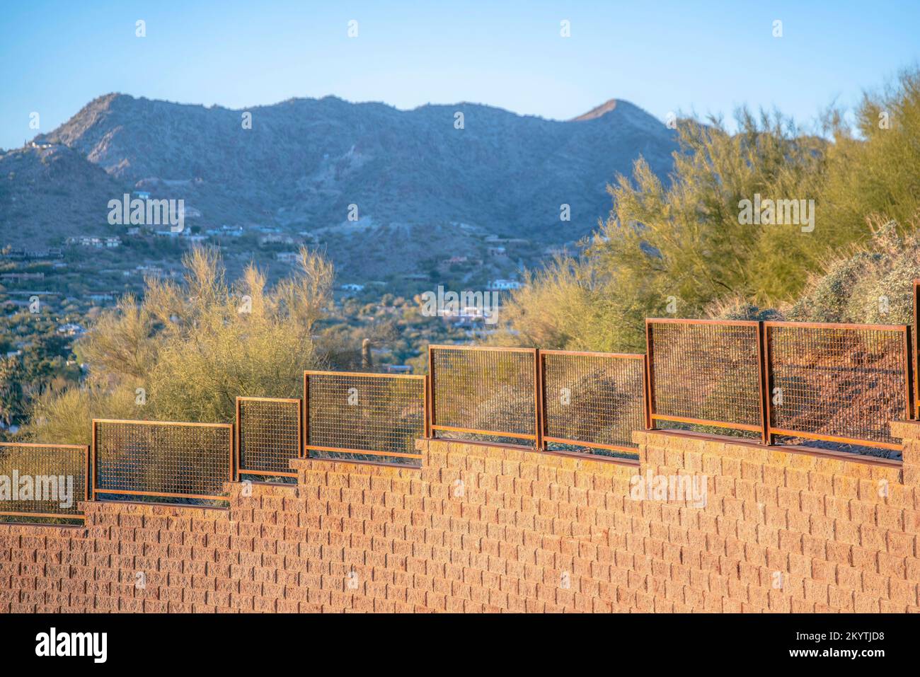 Phoenix, Arizona- Slope with concrete retaining wall and metal fence at ...