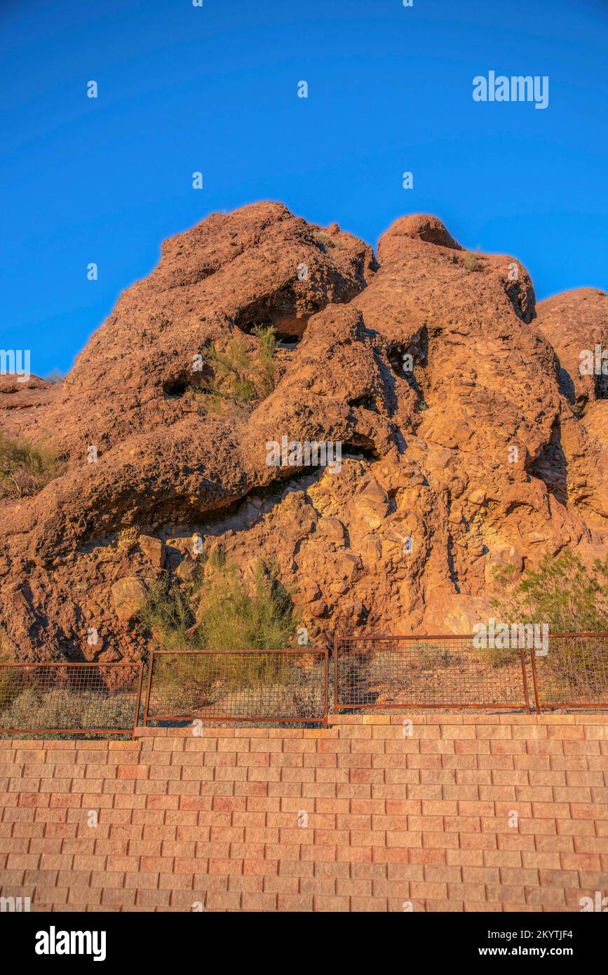 Phoenix, Arizona- Rock formation with wall and railing fence at ...