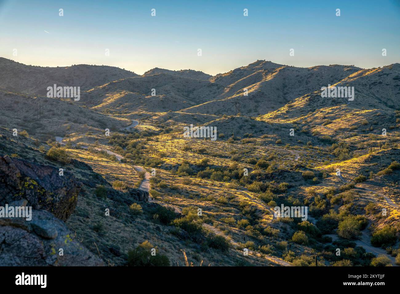 Phoenix, Arizona- Pima Canyon trail on a valley against the sunset ...