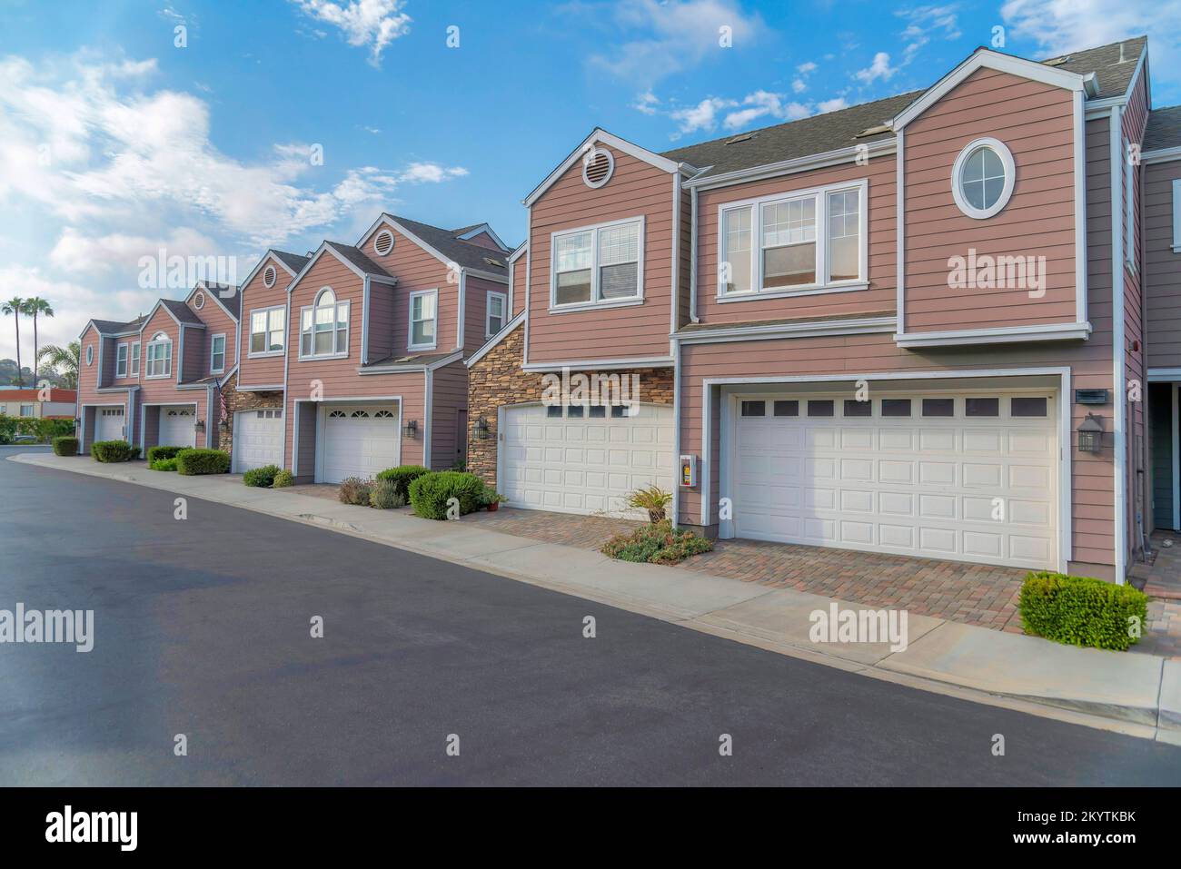 Townhouse garages with stones and plants on the driveway at Southern ...