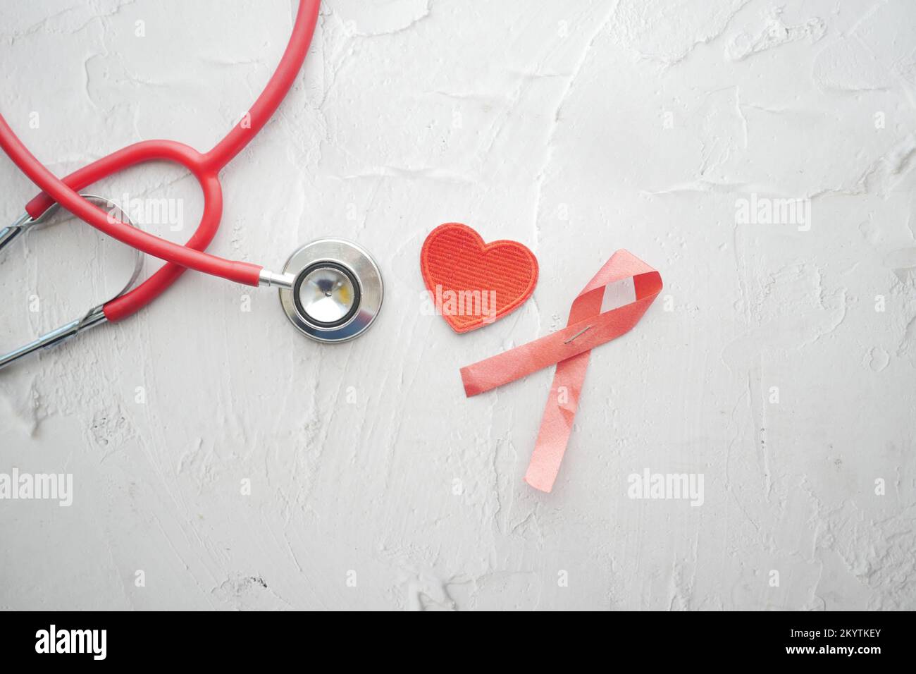Red ribbon HIV, and stethoscope on pink background Stock Photo - Alamy