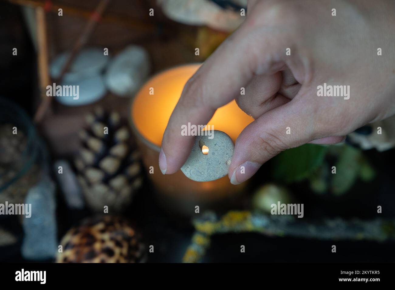 Witch hand holds adder stone. Magic items scene Stock Photo - Alamy