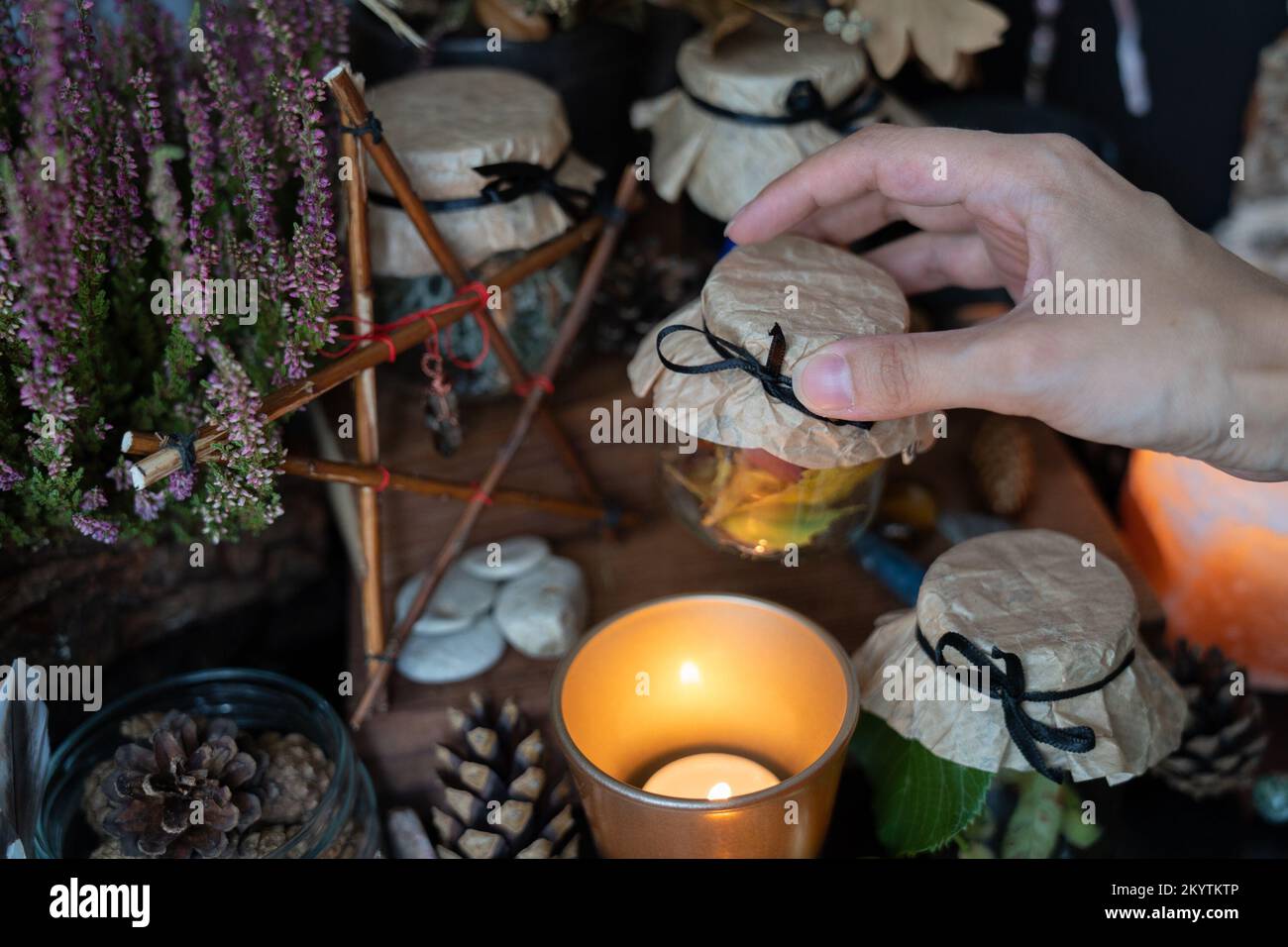 Witch hand holds magic potion. Magic items scene Stock Photo - Alamy