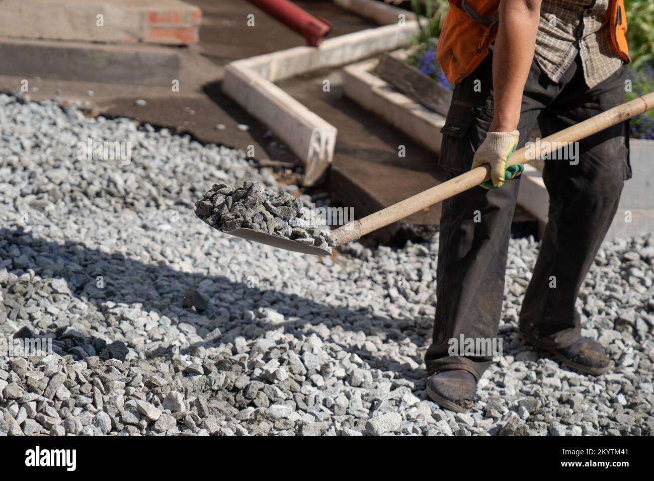 Male construction worker is loading gravel Stock Photo - Alamy