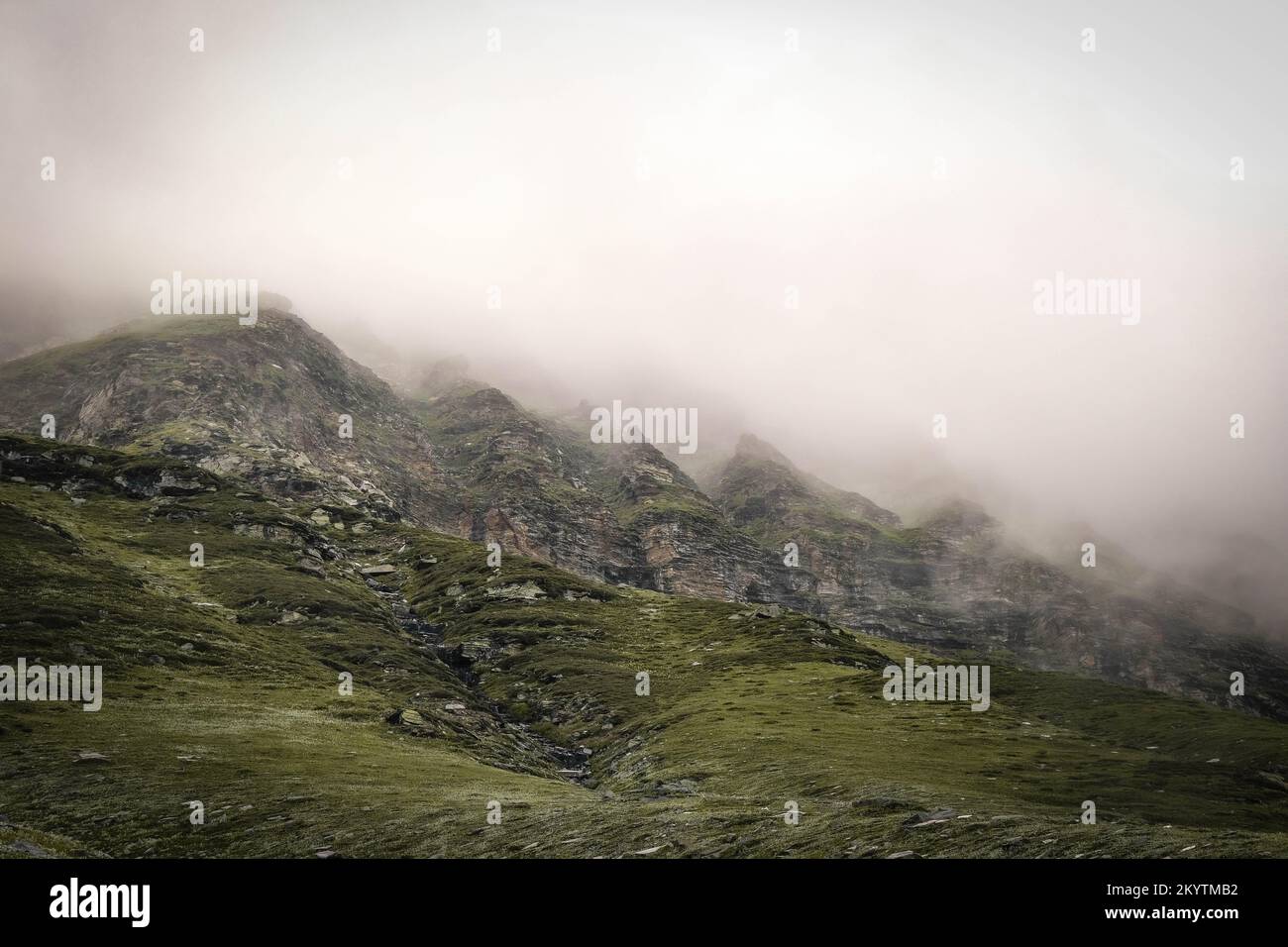 Cloud covered mountain picture Stock Photo - Alamy