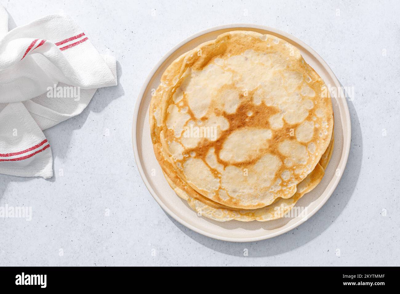 Crepes. Thin crepes on a plate. Top view Stock Photo - Alamy