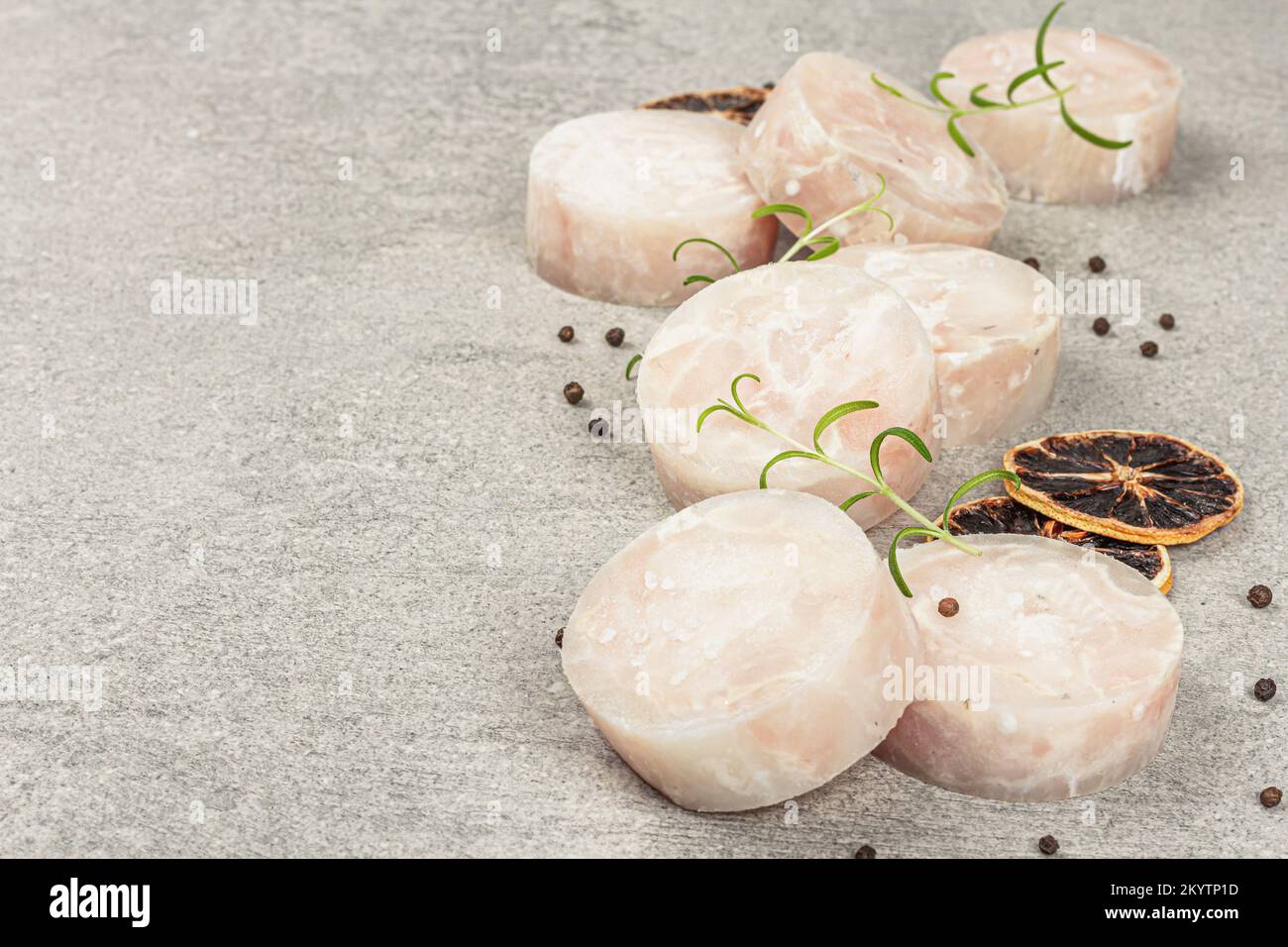 Chunks of frozen hake. Marine fish fillet on stone background, raw ...