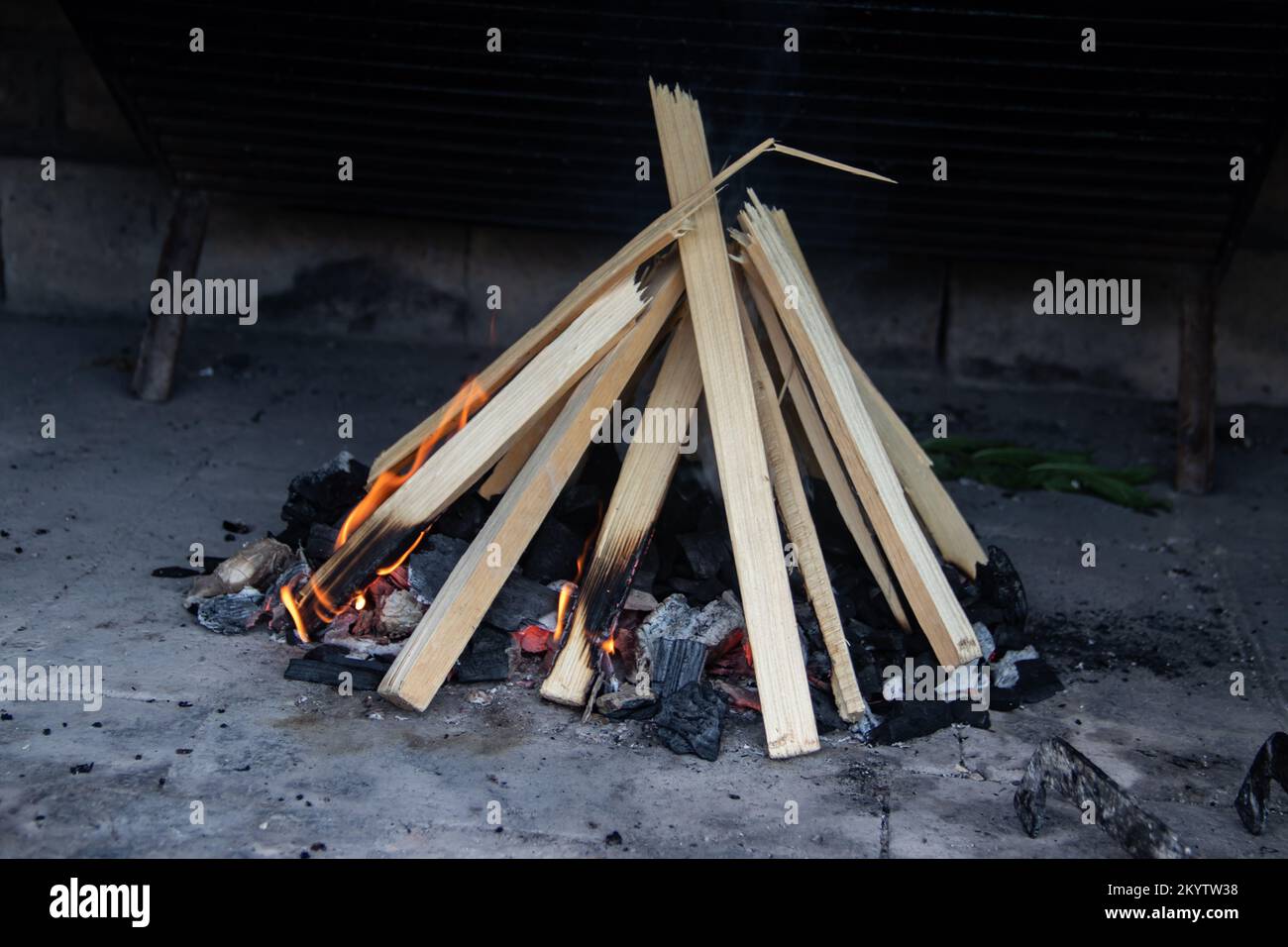 Small fire made of dried timber for barbeque preparation at picnic in ...
