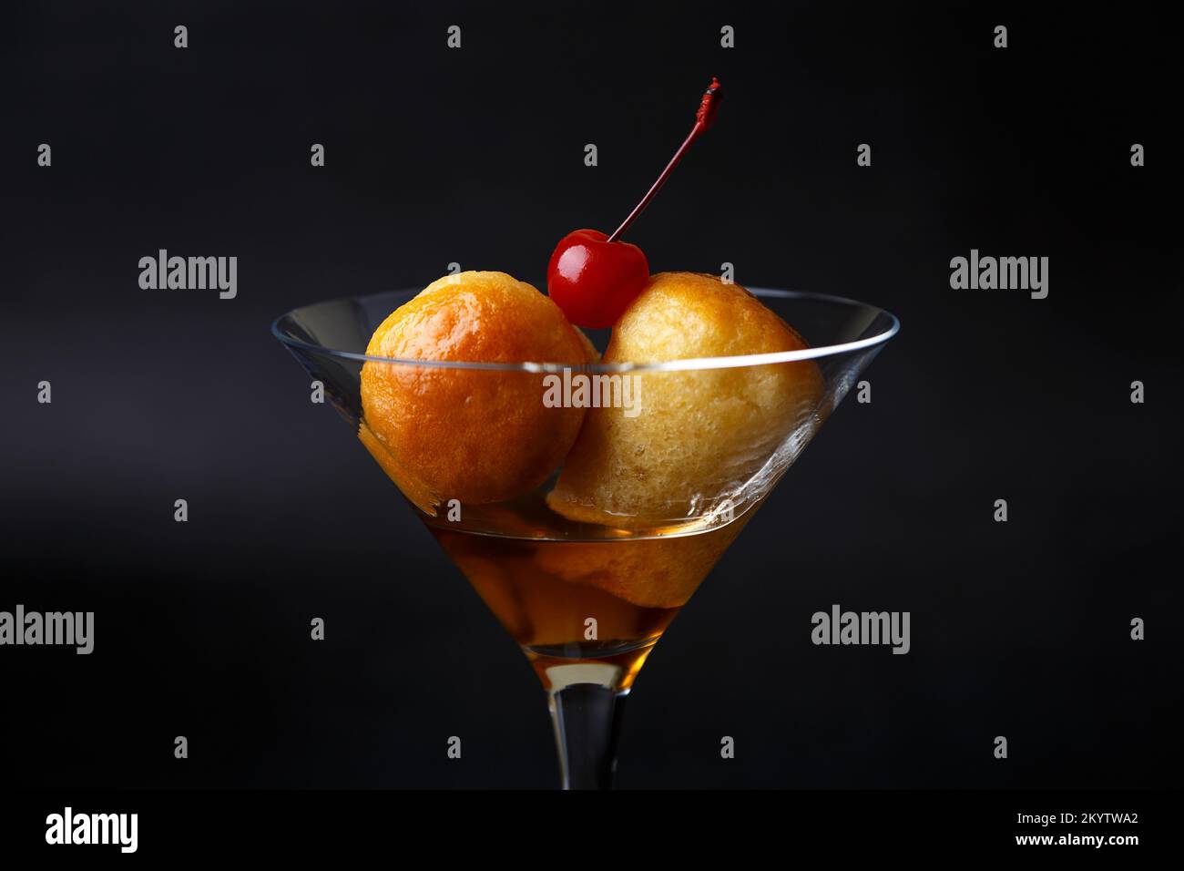 Neapolitan Rum baba (or baba au rum) in a martini glass with a cocktail ...