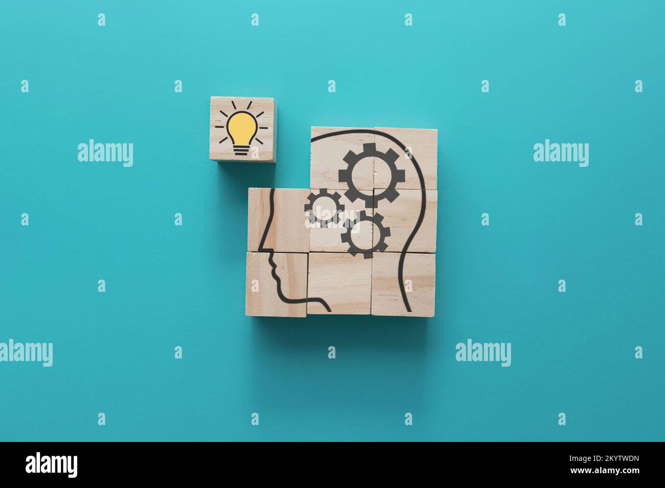 Human head outline on wooden blocks with missing piece light bulb, problem solving, creativity ...