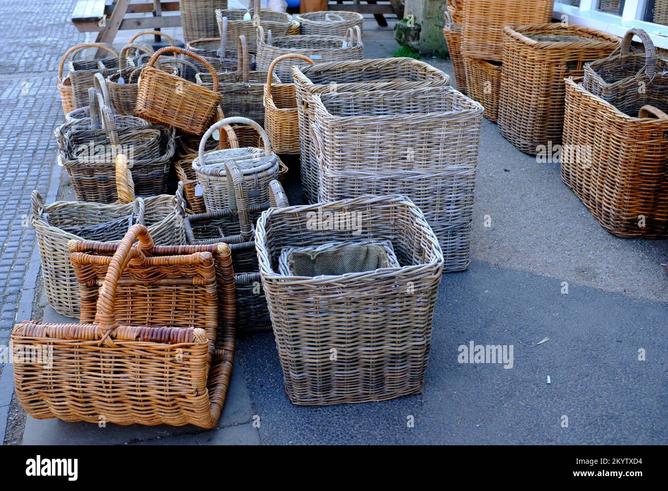 Wicker baskets of various sizes displayed for sale on the pavement ...