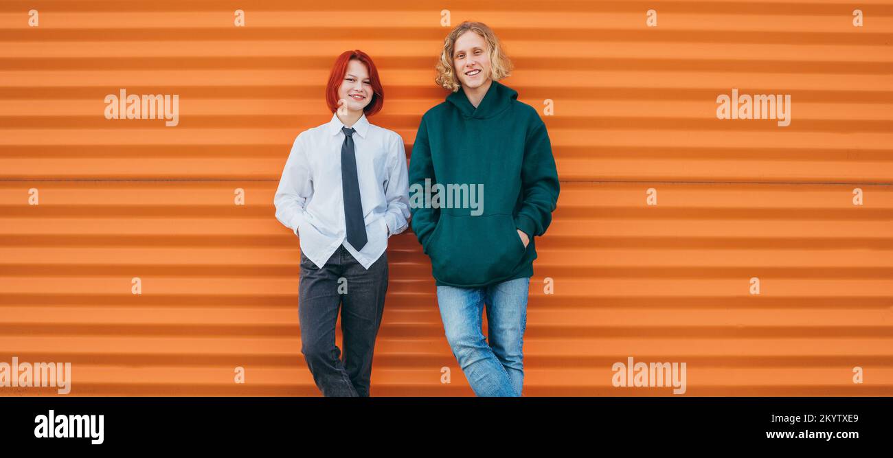 Portraits of two smiling caucasian teen friends boy and girl posing for ...