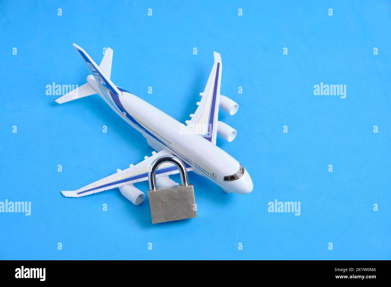 Passenger plane and lock on blue background.Concept of ban passenger ...