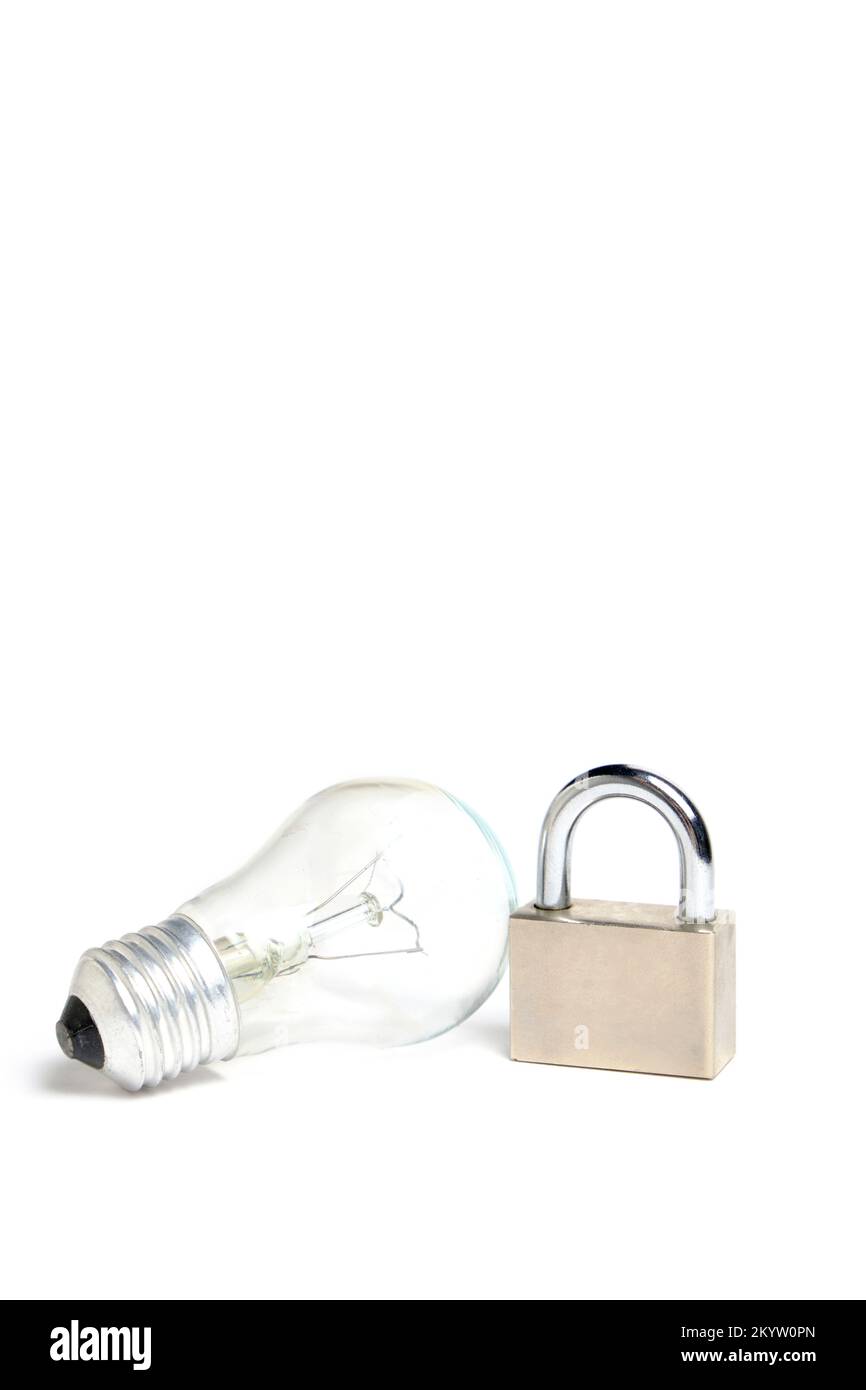 Incandescent lamp and lock on white background.Concept of power outage ...