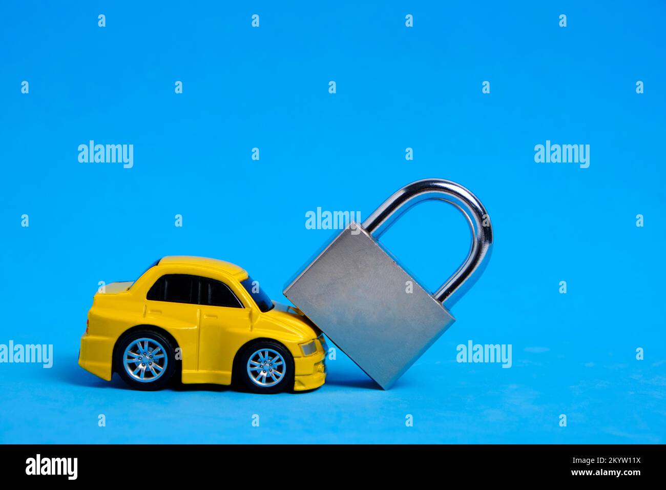 Toy car and lock on it blue background, concept prohibiting the sale ...
