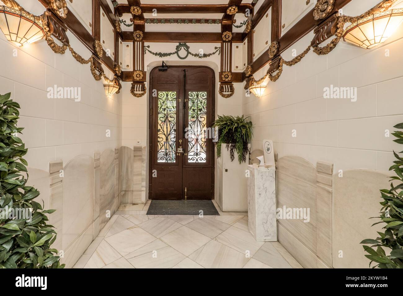 Interior of a portal of an old house with white marble floors and a ...