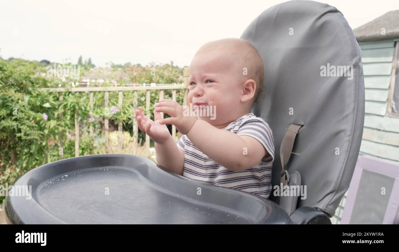 Woman feeding Tired child with spoon. Mom feed crying Sad baby Boy with ...