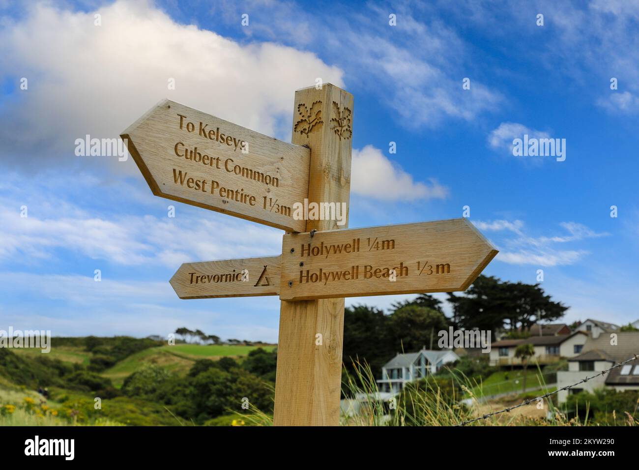 A National Trust wooden signpost saying Holywell, Holywell Beach, The ...
