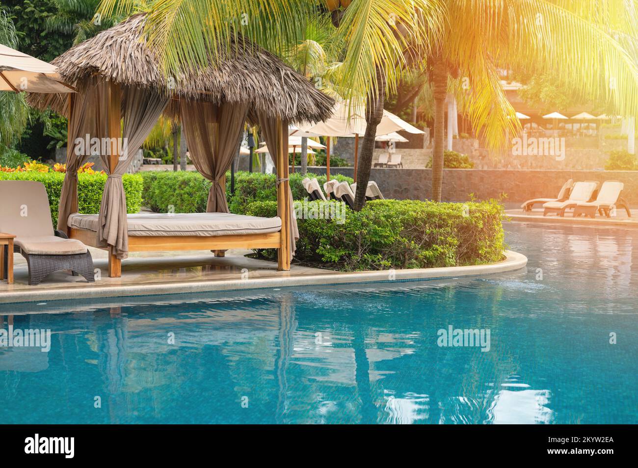 Big pool with canopy in tropical hotel resort Stock Photo - Alamy