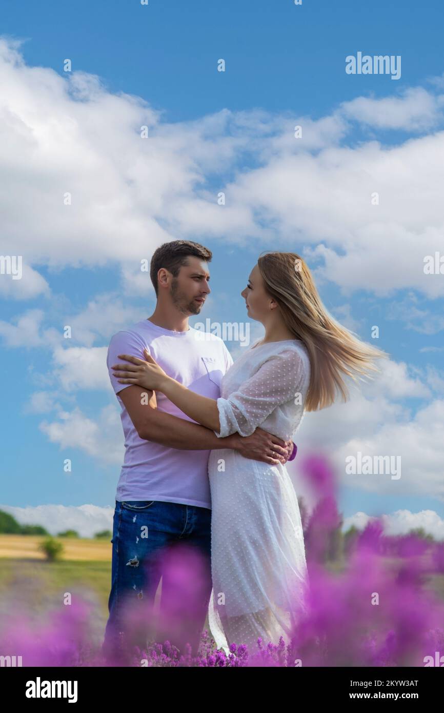 Beautiful purple lavender flowers in a summer field. couple holding ...