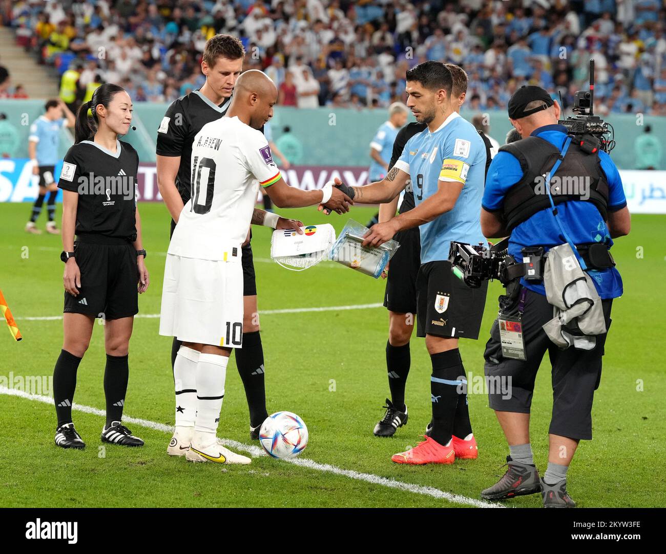 Uruguay's Luis Suarez (right) shakes hands with Ghana's Andre Ayew ...