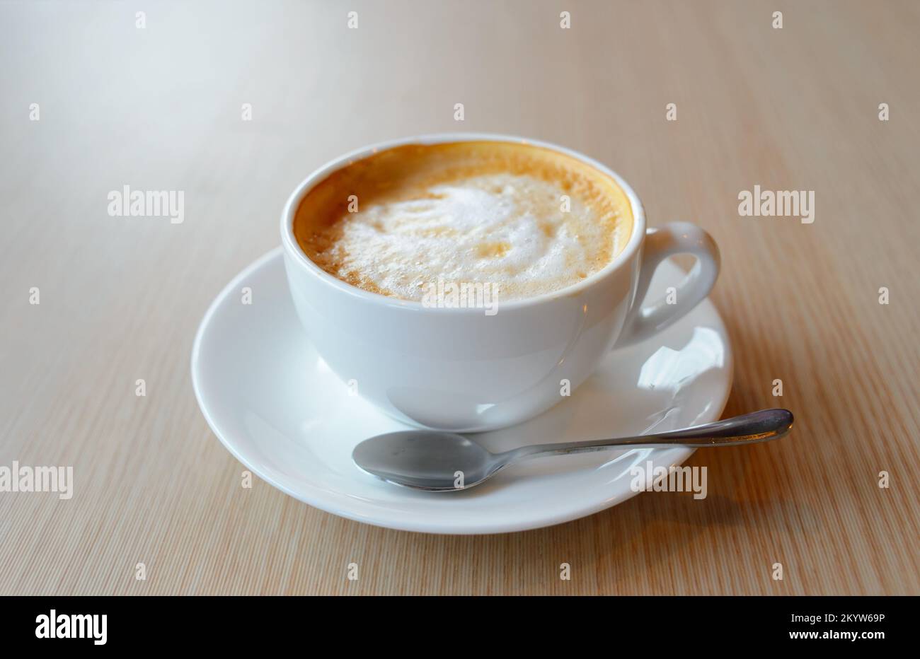 Close-up shot of white cup with hot latte on the table Stock Photo - Alamy