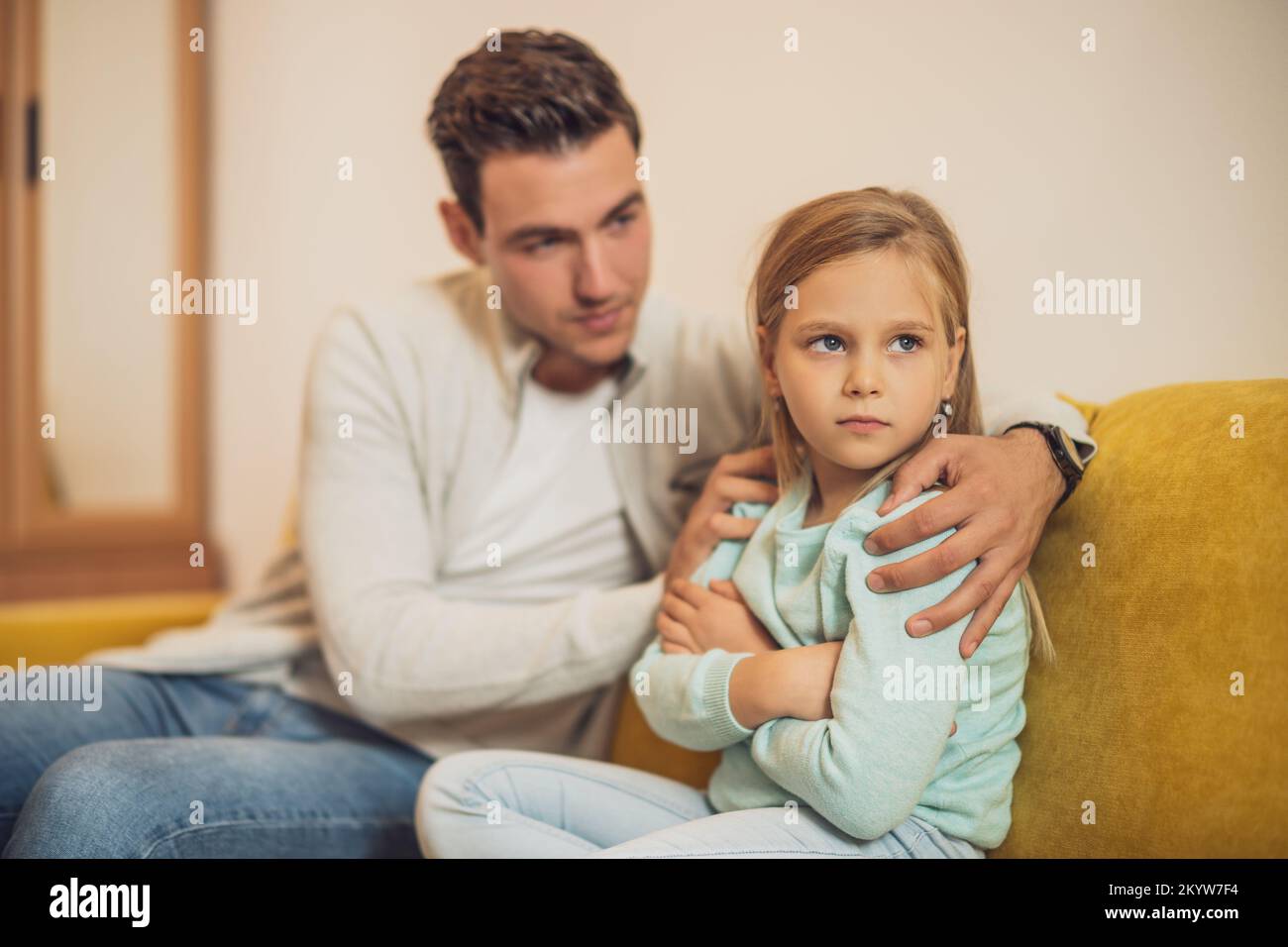 Little girl is angry after conflict with her father and he is trying to ...