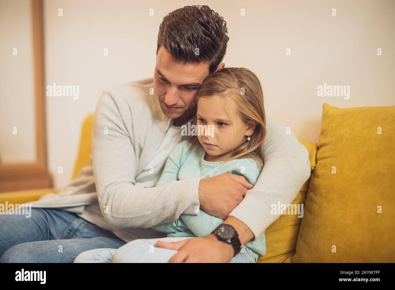 Little girl is angry after conflict with her father and he is trying to ...