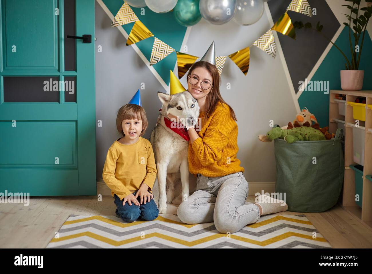 Dog pet birthday, family mother and child hug their dog congratulating ...