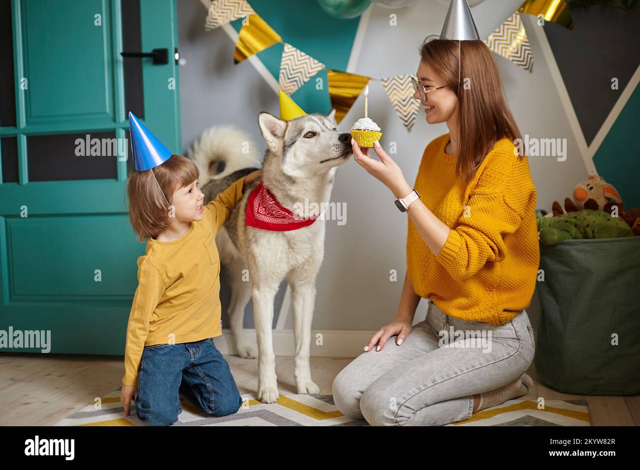Dog pet birthday party, Happy family mother and child congratulating ...