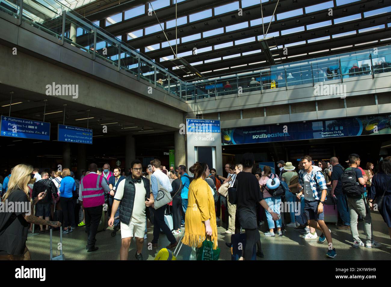 Passengers queue at St Pancras Station in central London, as many ...