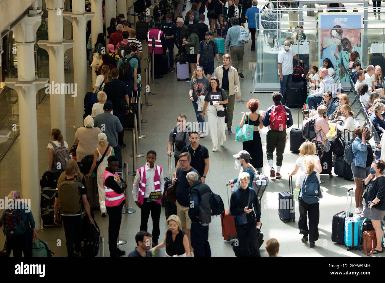 Passengers queue at St Pancras Station in central London, as many ...