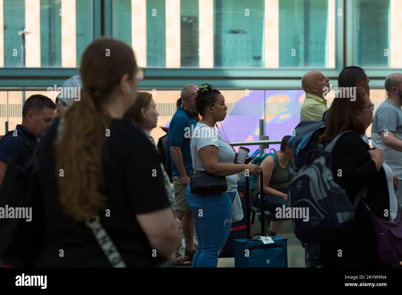 Passengers queue at St Pancras Station in central London, as many ...