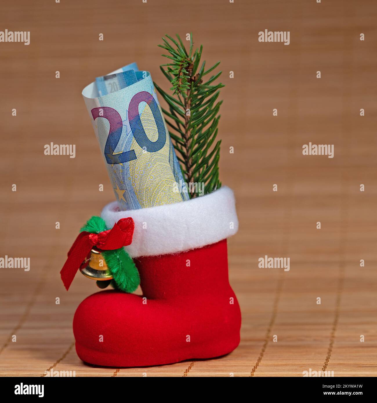 Santa's boots with banknote and fir branch Stock Photo - Alamy