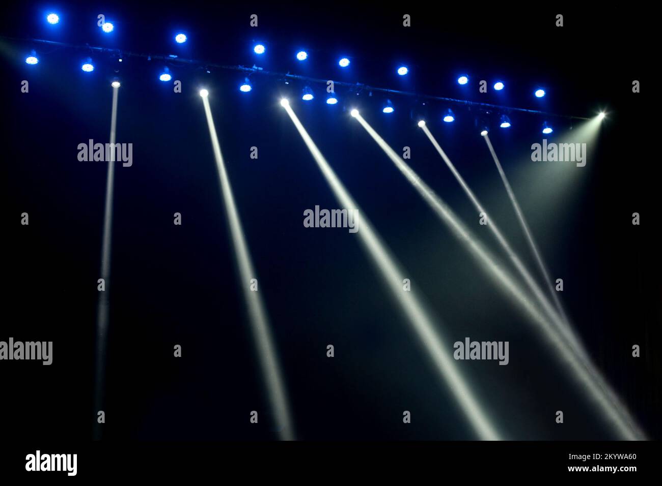 Blue and white concert stage lights on black background Stock Photo - Alamy