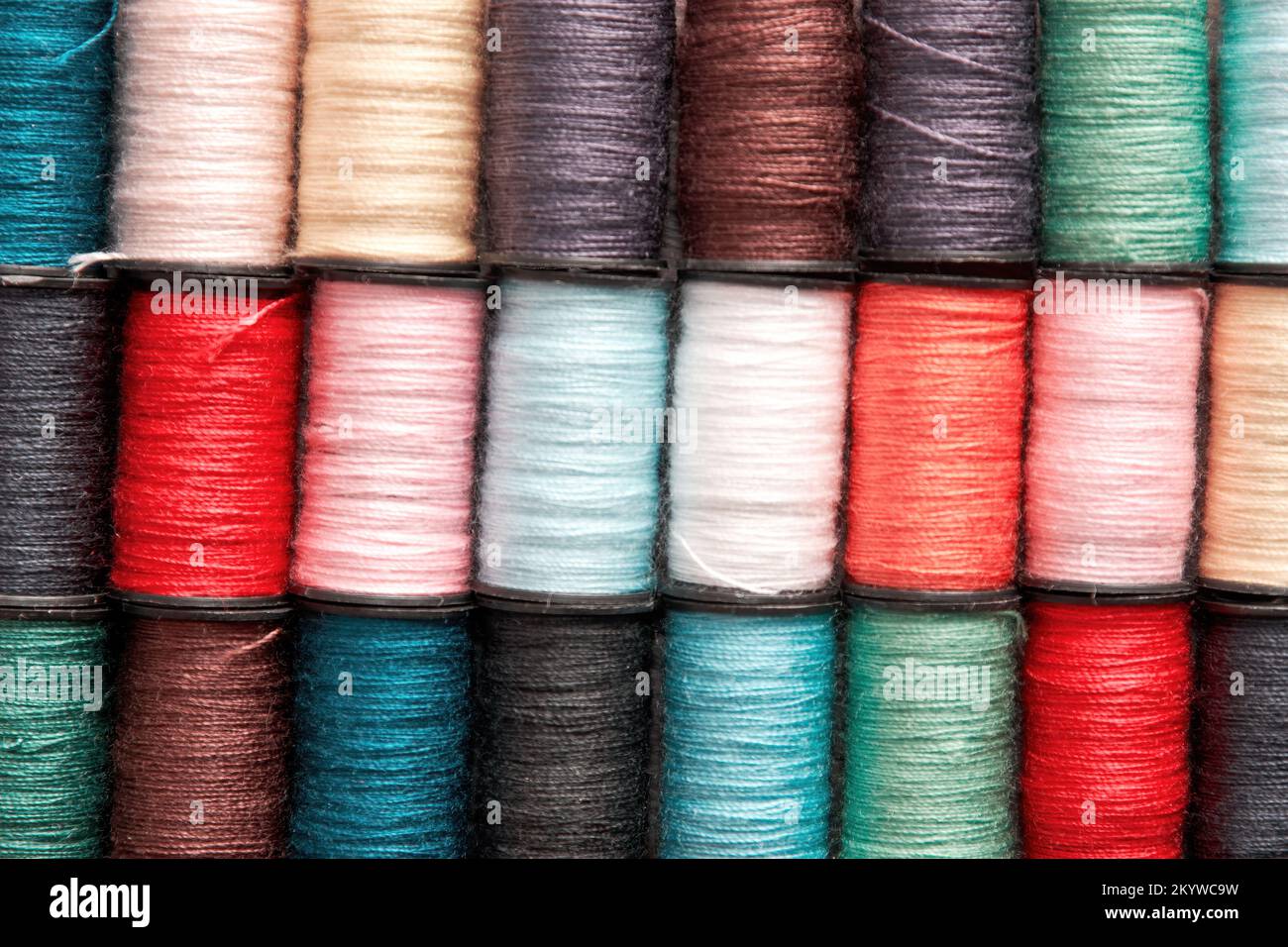 Pink and turquoise colored thread reels pattern texture. Embroidery ...