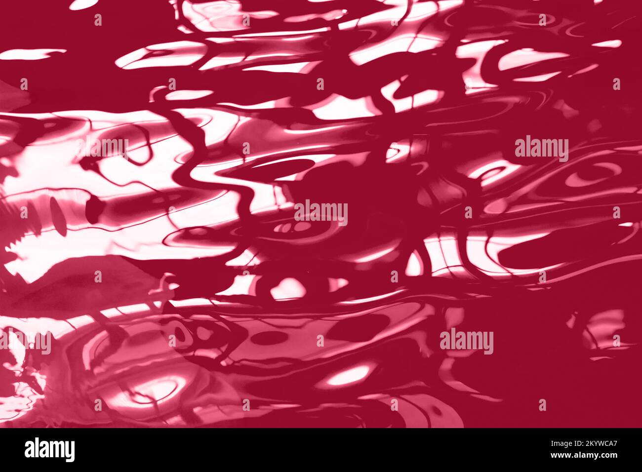 Pool water in viva magenta color with sun reflections. Abstract blurred ...