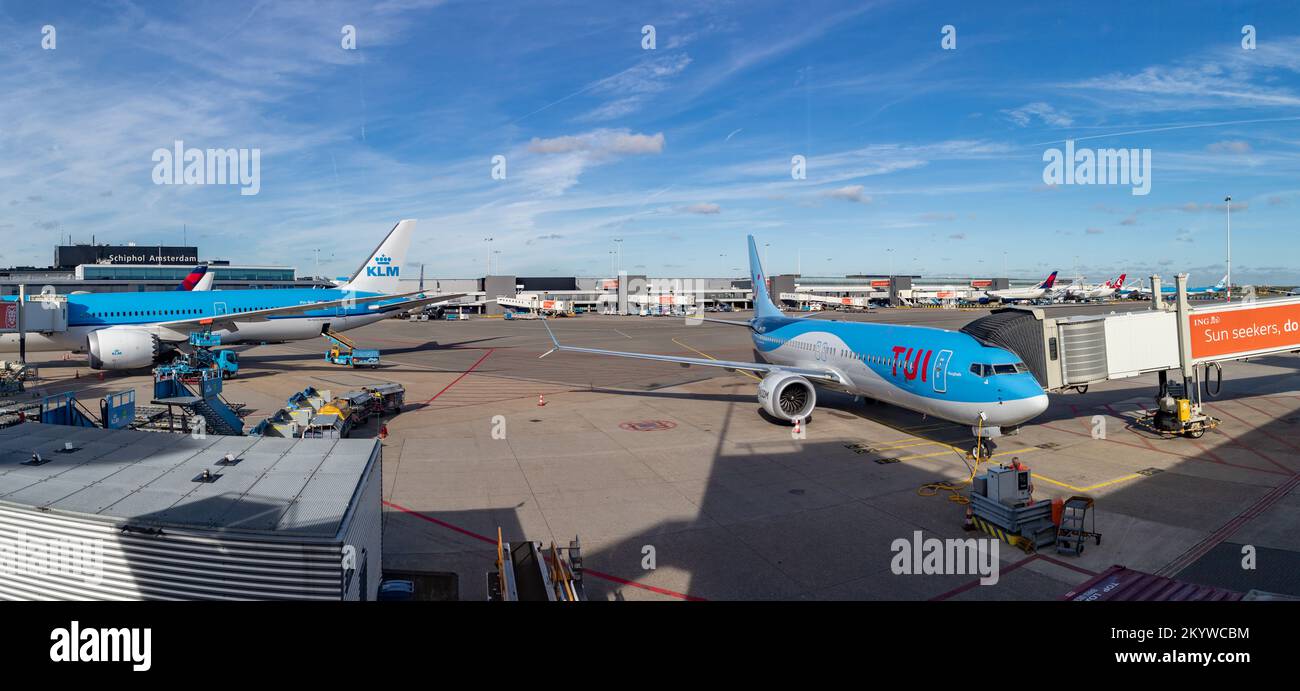A panorama picture of multiple planes in the Schiphol Airport Stock ...