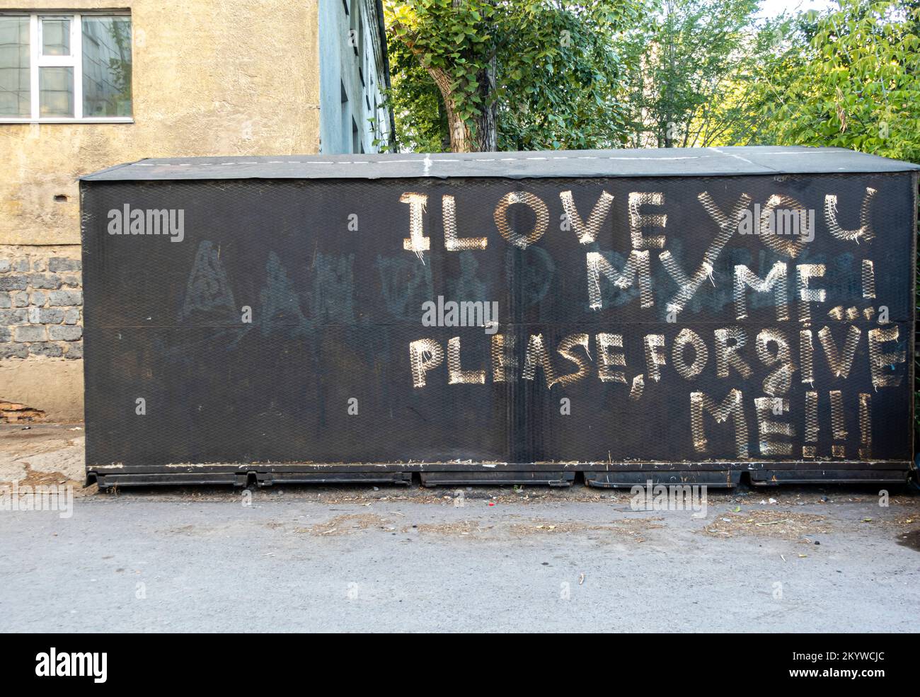 Vandalised wall of a metal garage- "I love you my MF. Please forgive me ...