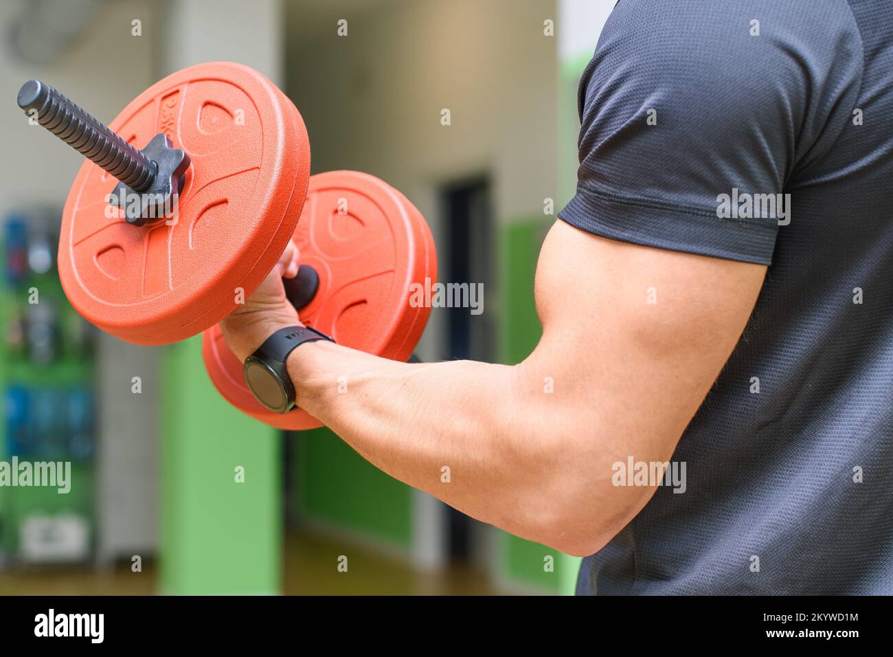 A young boy while working out in the gym with a dumbbell weights Stock ...