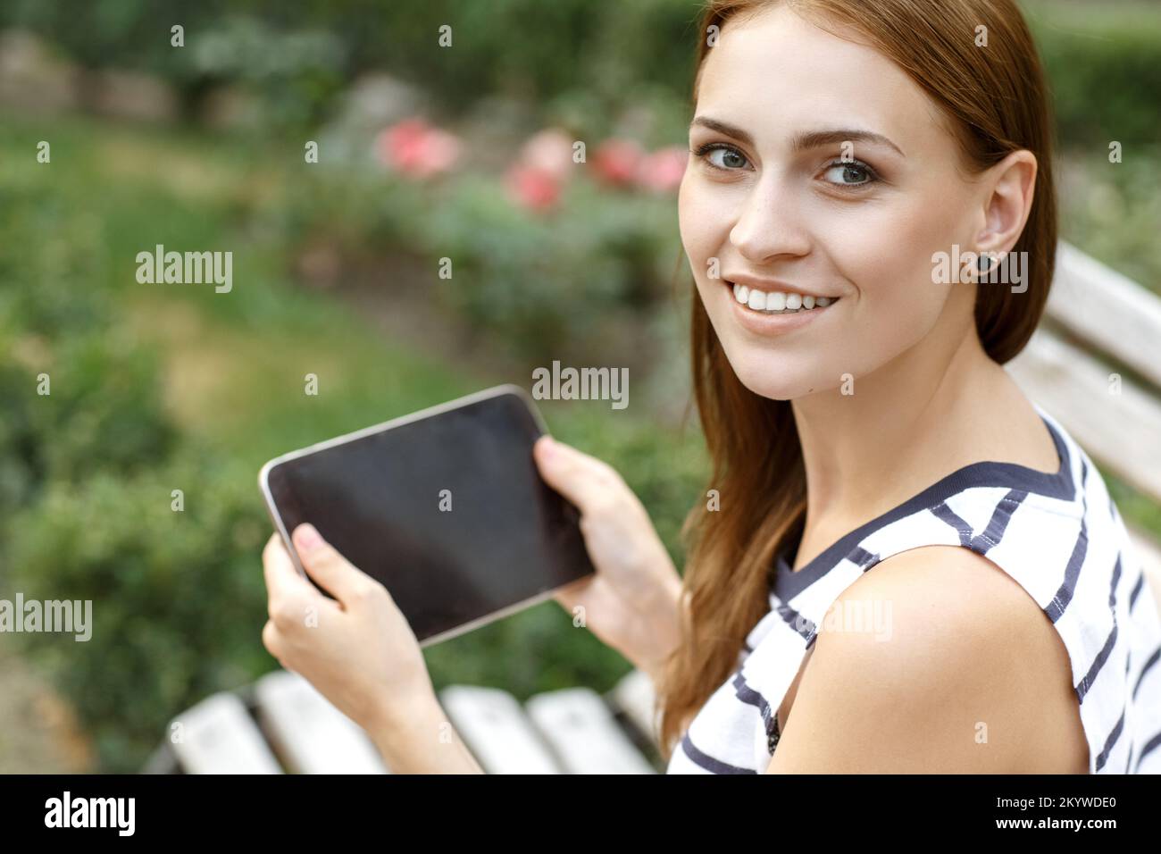 Pretty young woman shopping online with tablet device Stock Photo - Alamy