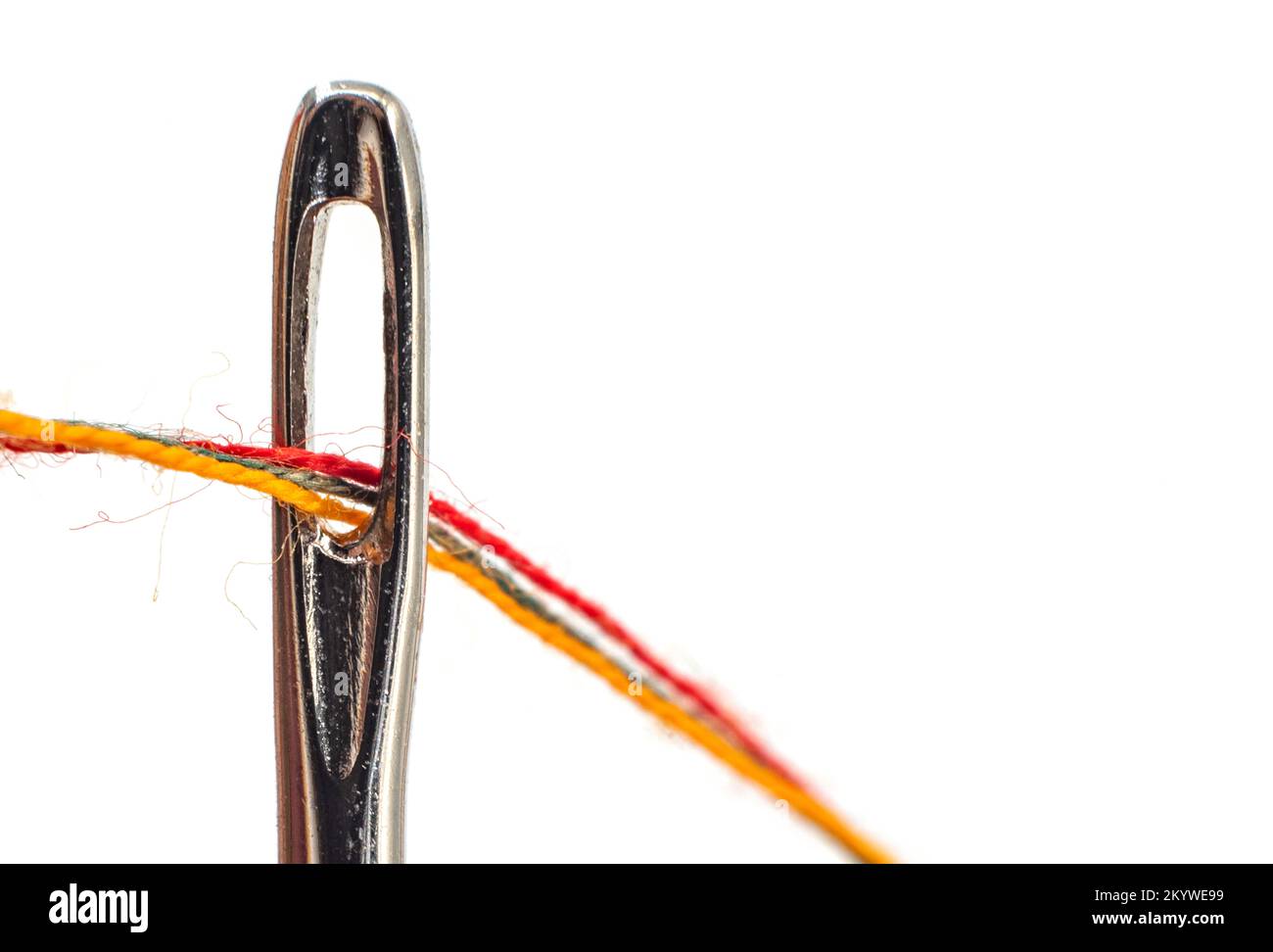 Needle and thread on a white background close-up. Needle isolate with ...
