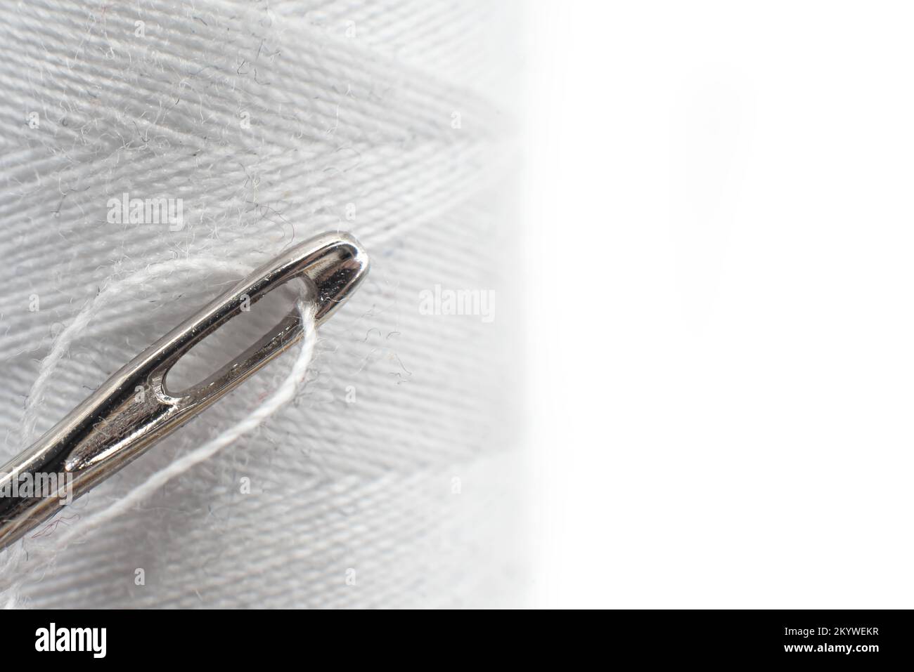 Needle and thread on a white background close-up. Needle isolate with ...