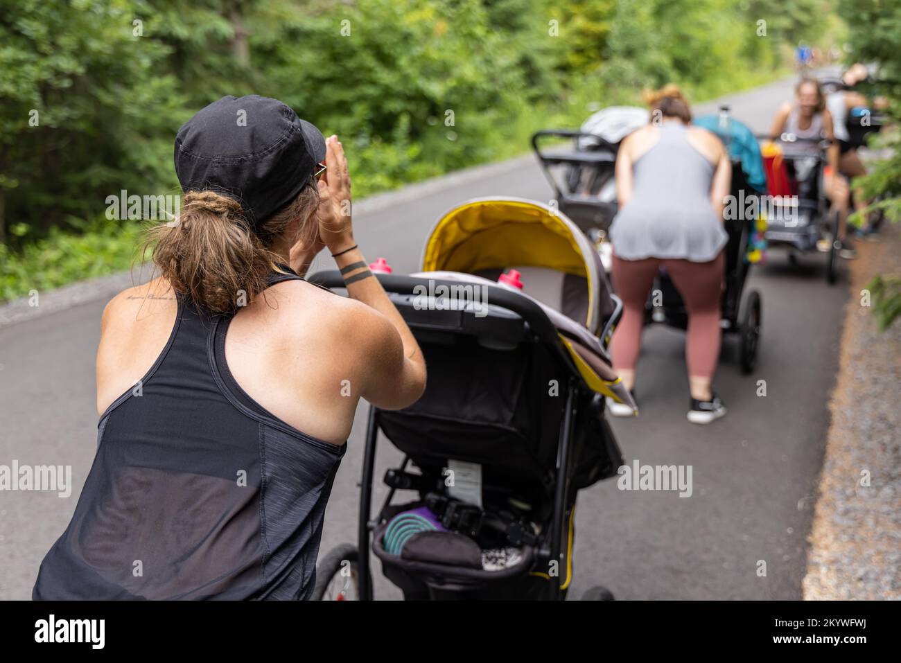 Backside photo taken from group of mothers participating in a cardio ...