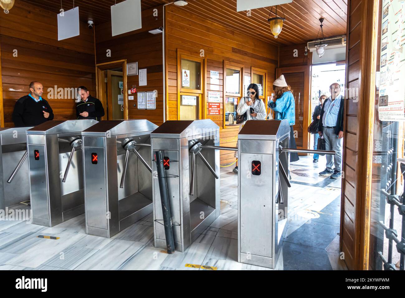 Passengers enetering Karakoy Boat station. Turnstile gate entrance to ...