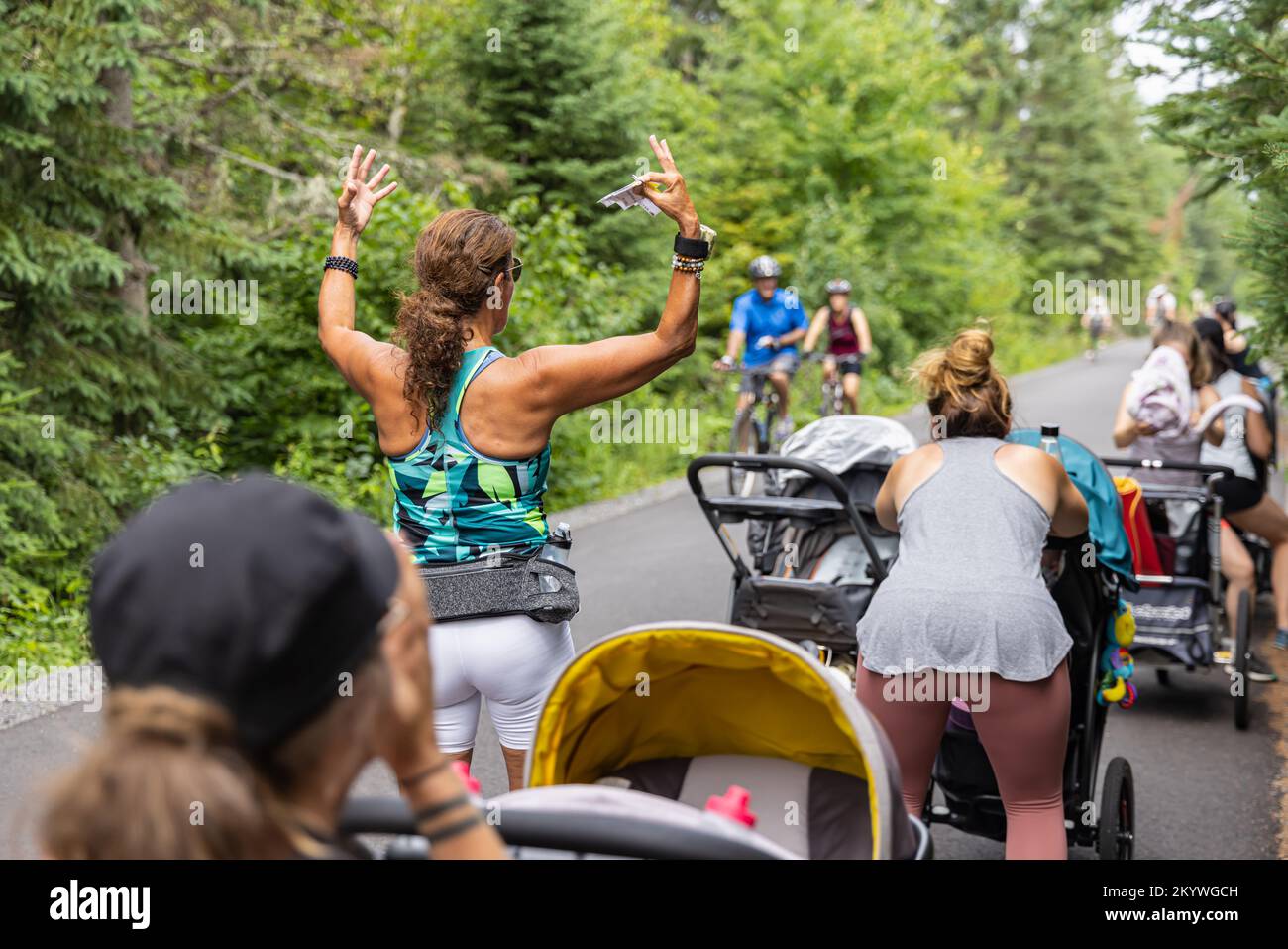 Female cardio instructor giving cardio and aerobic lessons to group of ...
